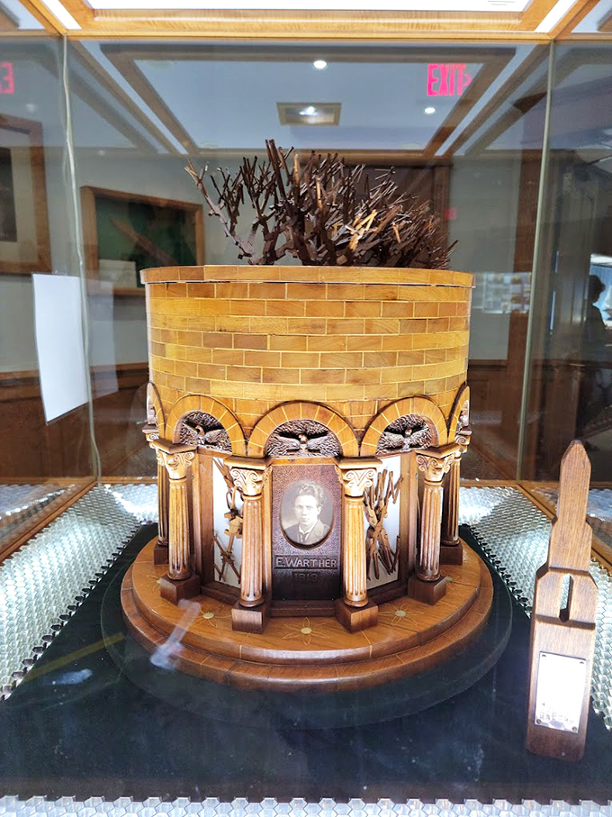 A tribute fit for a carving king! This ornate wooden structure showcases Mooney Warther's legacy, proving his craft was anything but wooden.