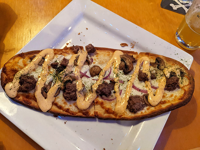 A savory masterpiece topped with mushrooms and drizzled with sauce - proof that flatbread can make you weak in the knees.