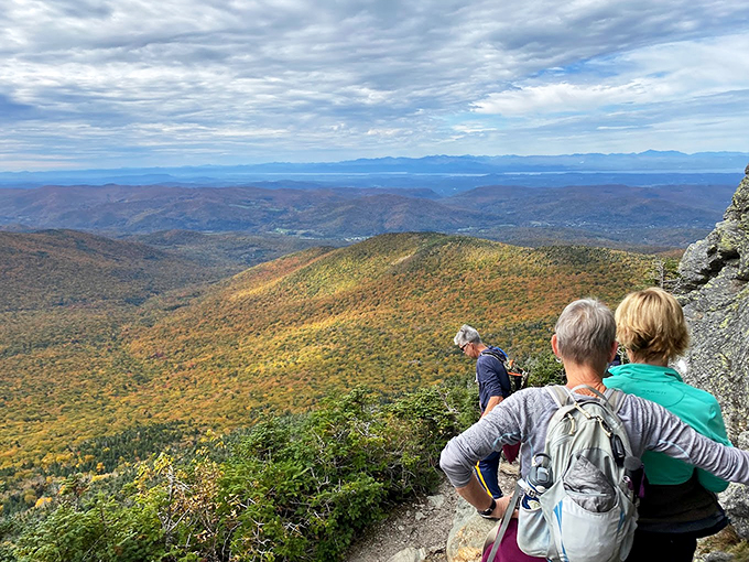 Summit selfie time! These hikers look like they've just conquered Everest, but with better cell reception and less risk of frostbite.