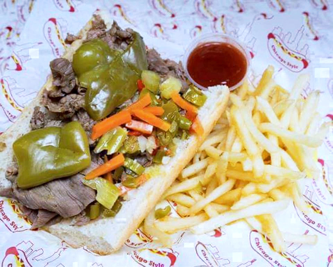 The classic Chicago combo: two dogs draped in traditional toppings, with a golden pile of fries standing guard.