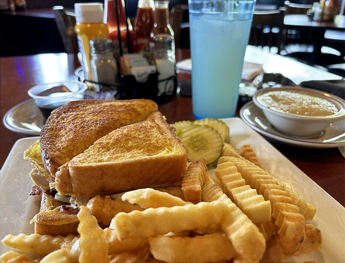 Golden-grilled perfection meets diner sophistication, served with a mountain of those addictive crinkle-cut fries.