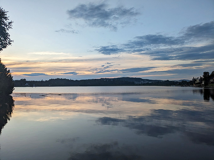 Joe's Pond mirrors the sky at sunset, creating a double helping of Vermont beauty that would make Bob Ross reach for his paintbrush.