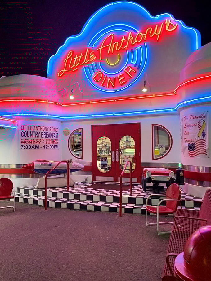 As the sun sets, Little Anthony's neon sign transforms into a beacon of retro cool against the desert twilight.