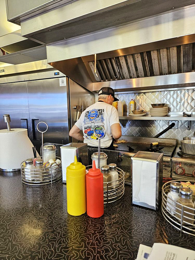 Where the magic happens - watch as short-order wizards transform simple ingredients into diner classics with practiced precision.