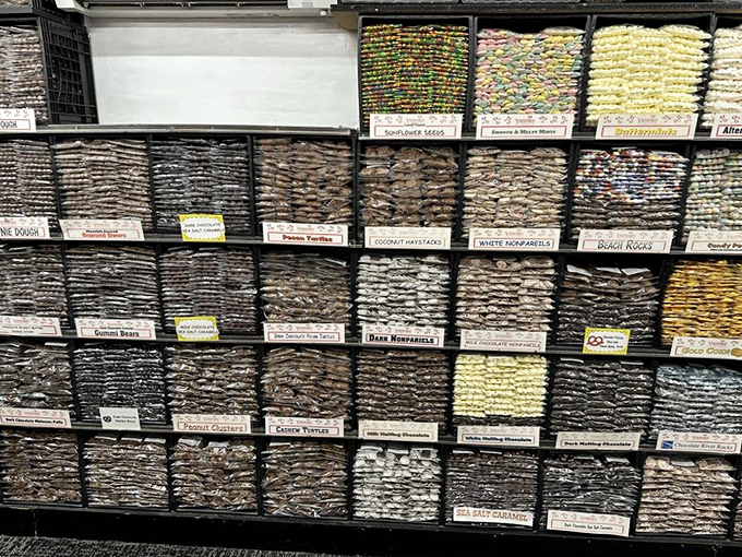 Shelves packed tighter than a holiday suitcase, each bag promising its own sweet adventure.