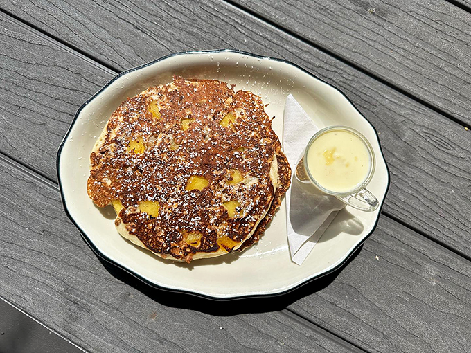Golden-brown pancakes dotted with fresh fruit, waiting patiently for their maple syrup moment.