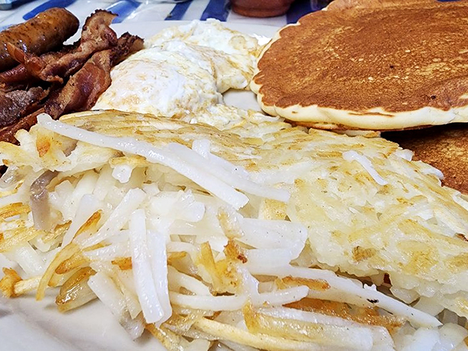Pancakes, Sausage Links, Bacon Strips, and Hashbrowns] The breakfast grand slam! This plate has more hits than the Beatles, and it's just as satisfying.