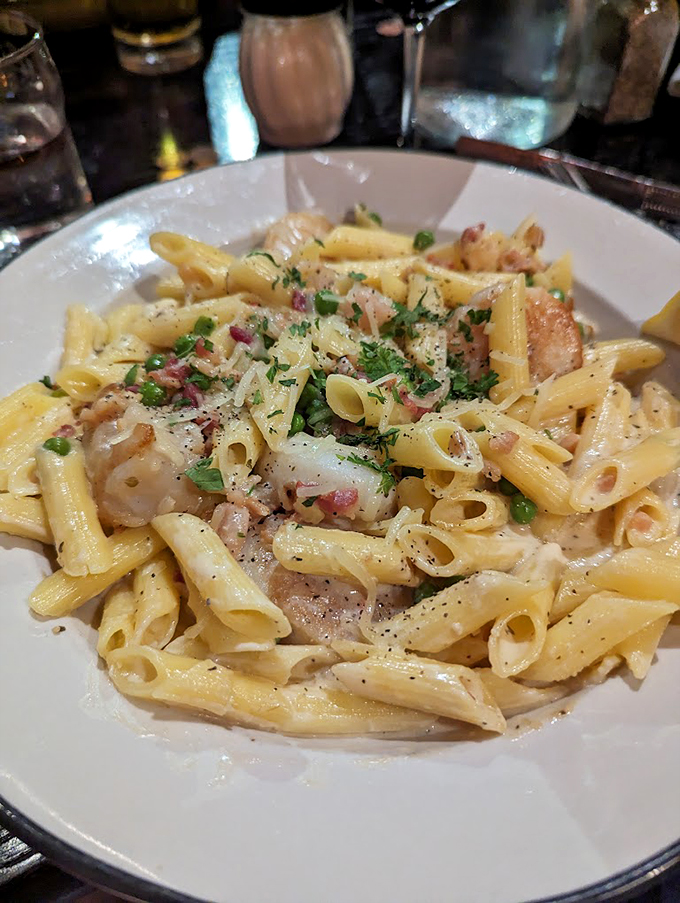Penne pasta dances with pancetta and peas in a creamy symphony that would make any nonna proud.