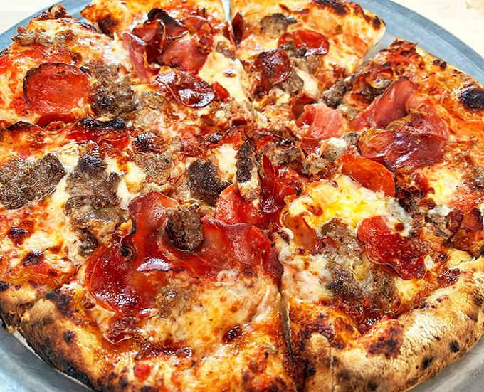 A pizza that doesn't play by the rules - loaded with meats and perfectly charred crust. Naples meets New England.
