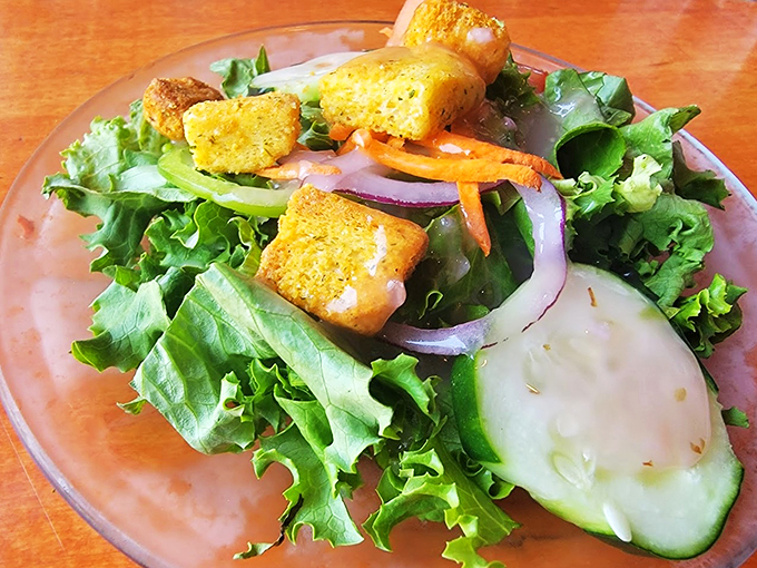 Crisp greens and golden croutons dance with fresh vegetables &ndash; proof that even salads can have personality.