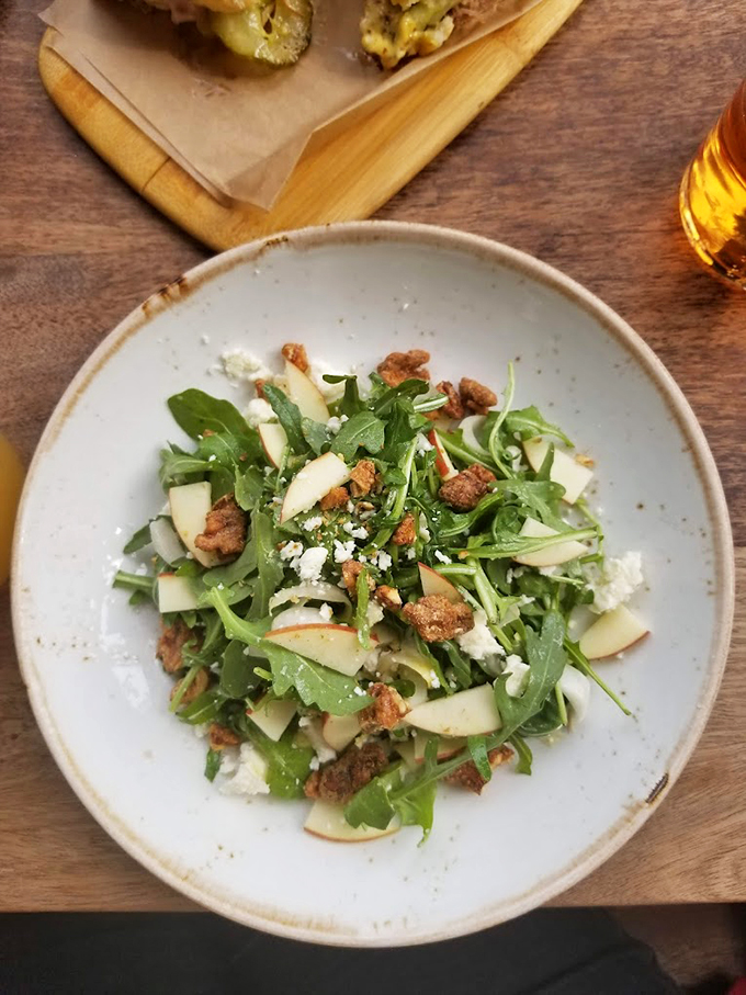 Fresh greens dancing with apple slices and nuts &ndash; proof that healthy eating doesn't have to be a boring affair.