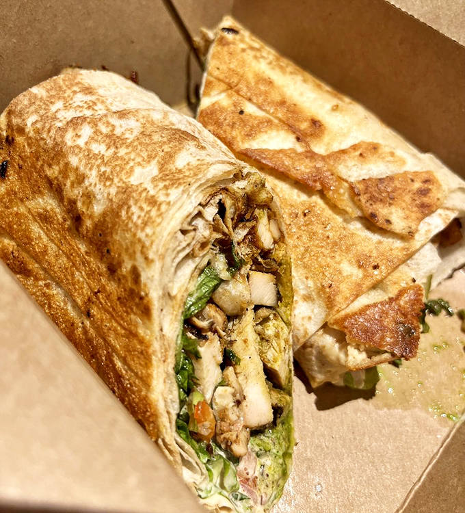 Crisp vegetables and tender chicken embrace in a warm flatbread wrap - it's like a hug for your hunger.
