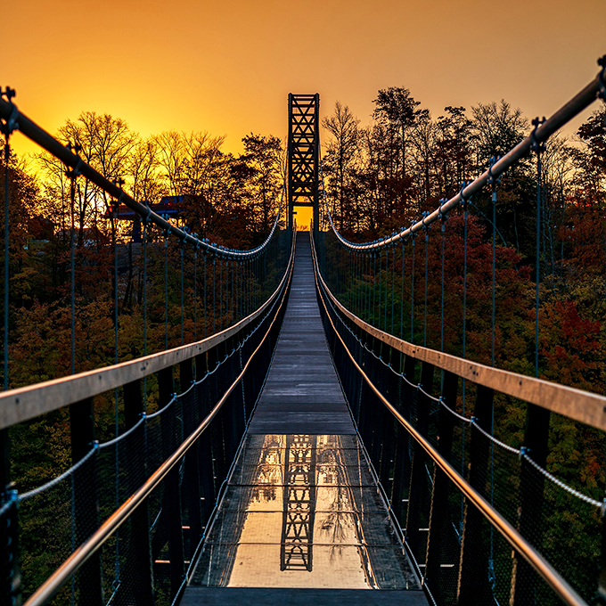 As day bids adieu, SkyBridge dons its evening attire. A glass floor reflects the fading light, turning every step into a dance with the sunset.