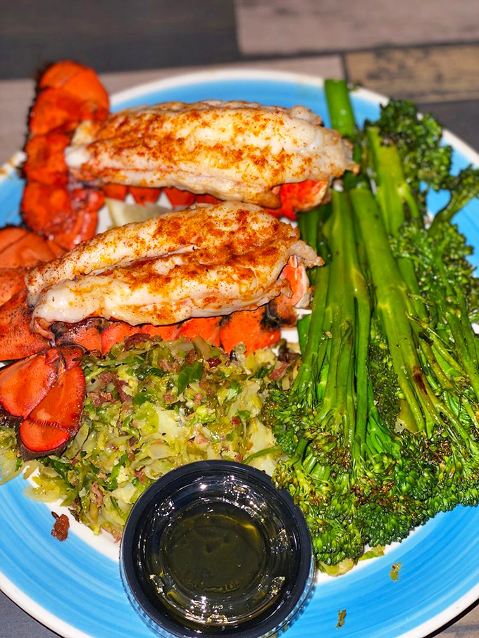 Perfectly grilled lobster tails share the plate with crisp broccoli, a simple yet elegant coastal feast.