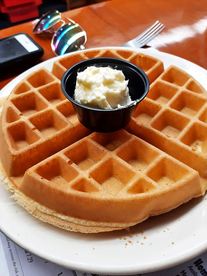 This Belgian waffle isn't just breakfast &ndash; it's a perfectly golden canvas waiting for its maple syrup masterpiece.