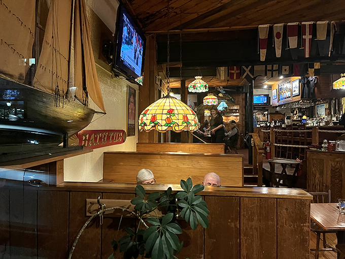 Welcome to the coziest corner of the seven seas! These booths are like a warm hug from a long-lost sea captain friend - if that friend happened to be exceptionally good at decorating.