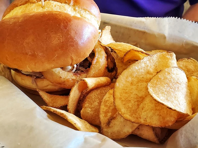 Behold, the star of the show! This burger isn't just a meal, it's a work of art that belongs in the Louvre... if the Louvre accepted delicious masterpieces.