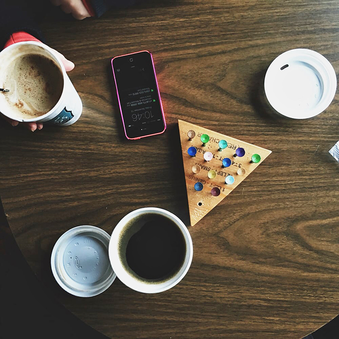 Simple pleasures done right: hot coffee, warm conversation, and a wooden table game that brings strangers together.