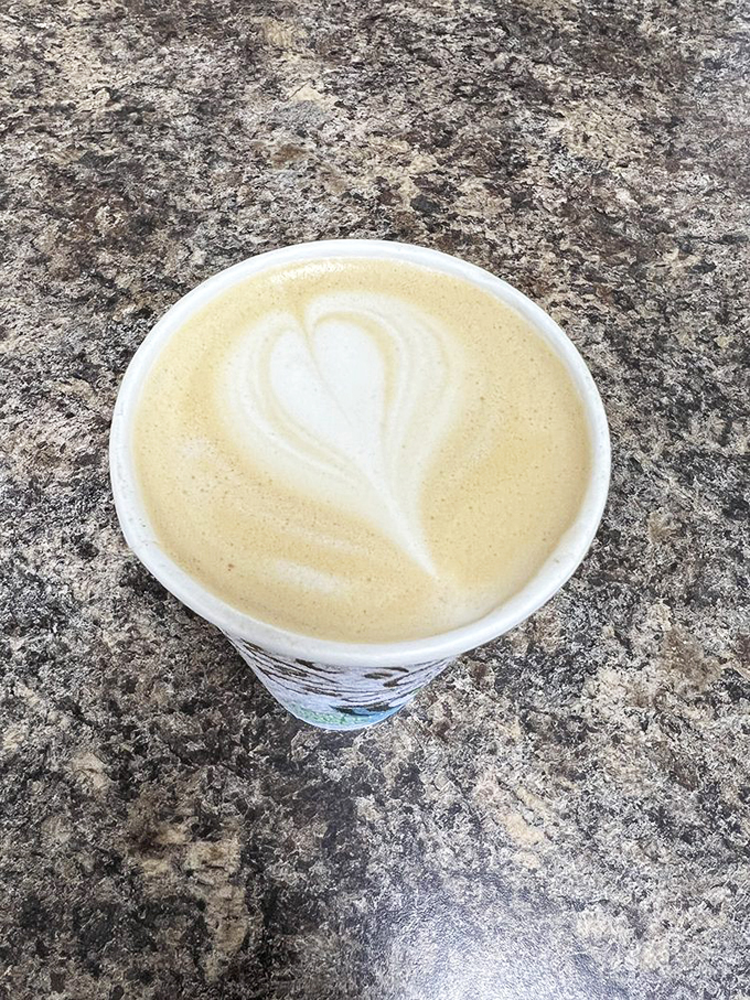 Latte art or edible Rorschach test? Either way, this creamy masterpiece is the perfect sidekick for your donut adventure.
