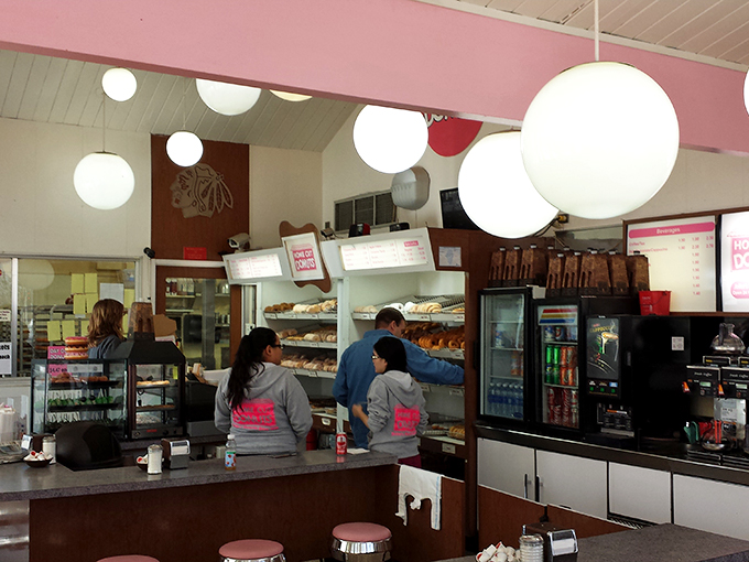 The donut dream team in action! These folks are the Avengers of the pastry world, assembling deliciousness one ring at a time.