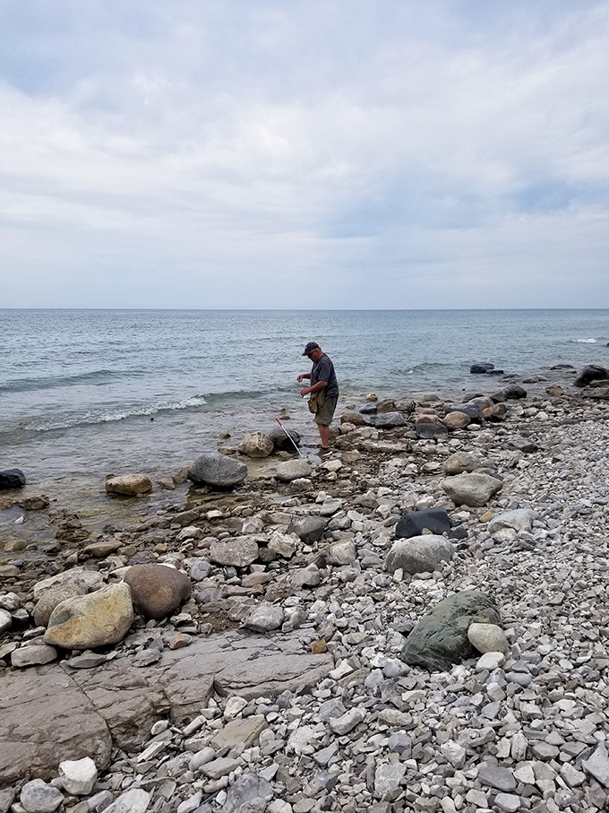 Rock-hopping: the original Fitbit. This intrepid explorer is getting his steps in while communing with Lake Michigan's stony shores.