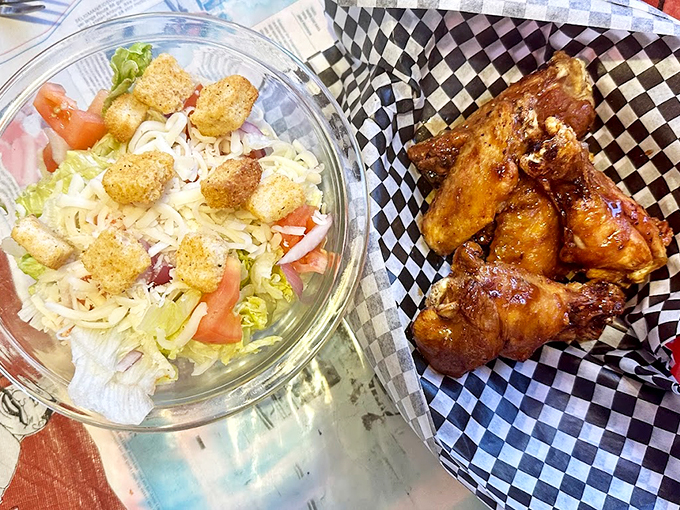 Fresh garden greens meet crispy croutons, while golden-glazed wings wait to steal the show on the side.