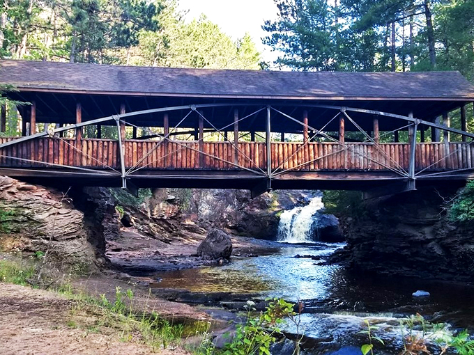 A rustic bridge over troubled waters? More like a picturesque crossing over nature's own water feature!