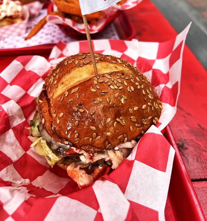 A burger that plants its flag in perfection territory, crowned with a sesame seed bun that gleams like culinary royalty.