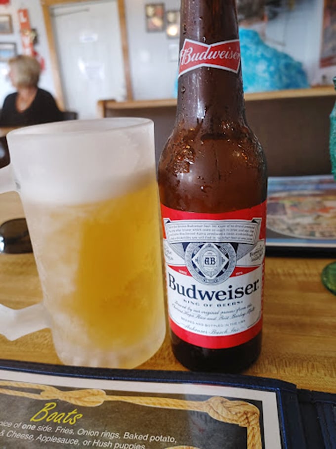 An ice-cold Budweiser waiting to meet its destiny alongside some seriously good seafood—life's simple pleasures.