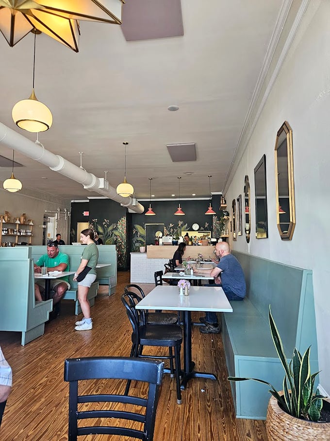 Mint-colored booths and golden pendant lights create the perfect setting for your "I found the best new breakfast spot" moment.