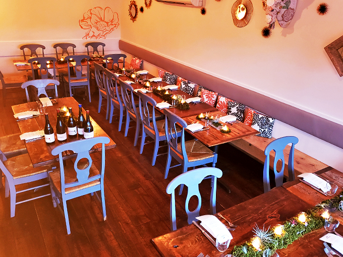Blue chairs, warm wood, and strings of lights create a dining room that's equal parts cozy and chic. It's like a hug from your stylish Spanish grandmother.