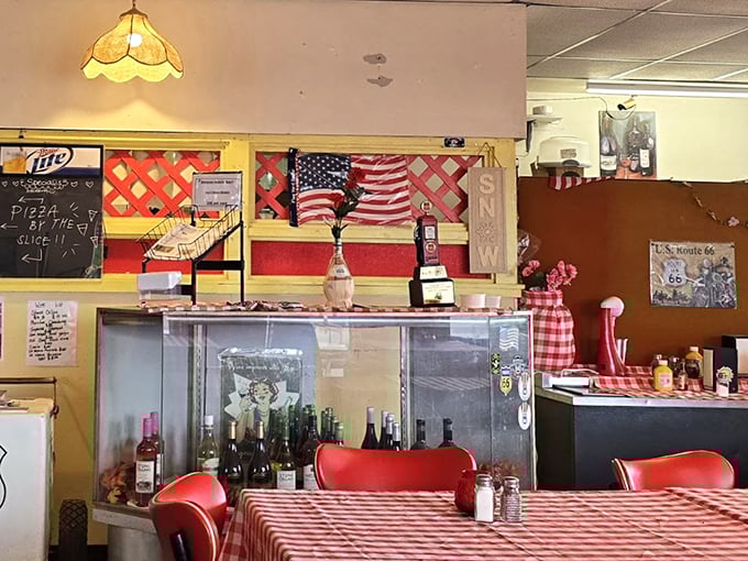 Red-checkered tablecloths and Route 66 memorabilia create that perfect small-town pizzeria atmosphere we all know and love.