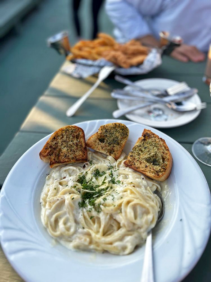 Pasta perfection with garlic bread companions - creamy fettuccine that would make an Italian grandmother proud.