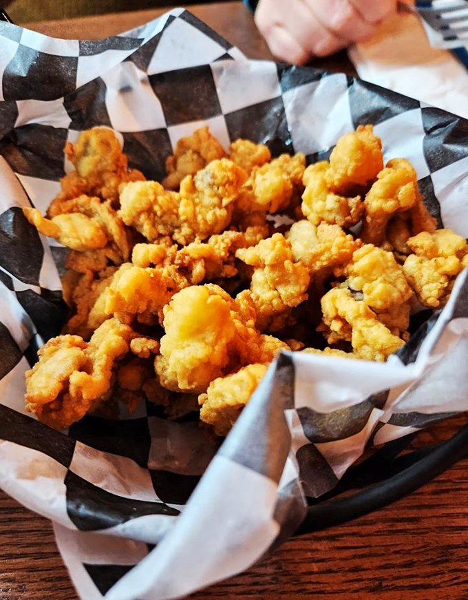 These golden-fried whole belly clams aren't just appetizers - they're little nuggets of oceanic happiness in a checkered basket.