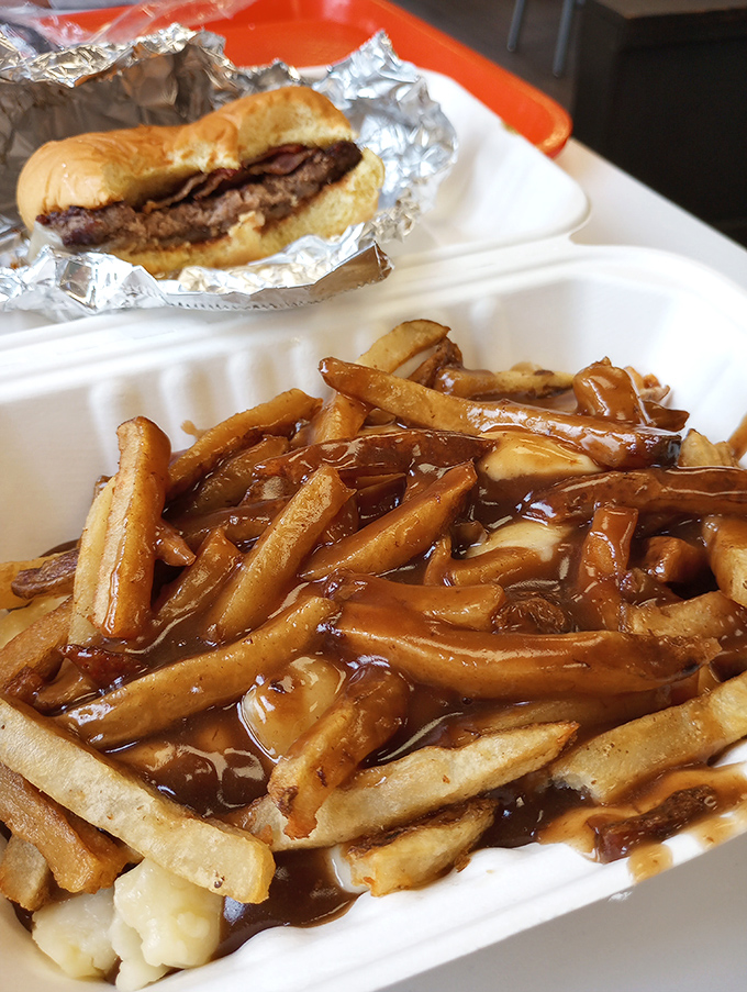 Poutine that would make our Canadian neighbors proud, with gravy cascading over hand-cut fries like a savory waterfall.