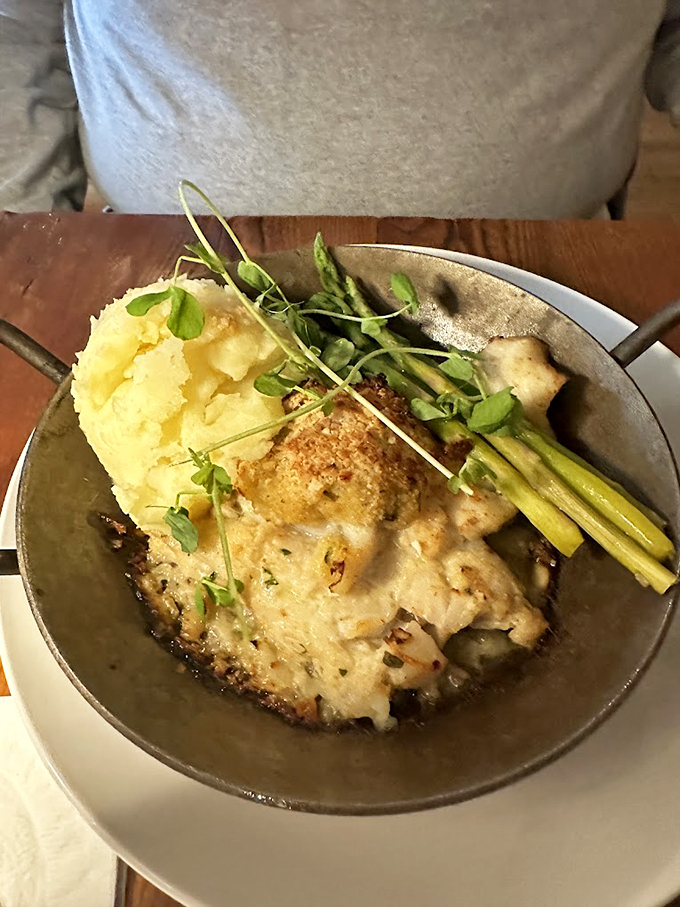 Comfort meets elegance: perfectly seasoned fish alongside golden mashed potatoes and fresh asparagus spears.