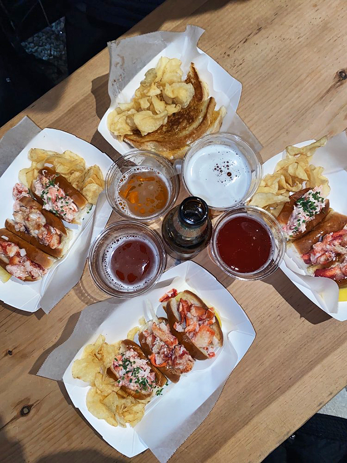 The ultimate Maine feast: craft sodas and lobster rolls arranged like a seafood lover's last supper.