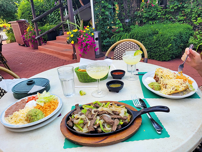 A feast fit for royalty: sizzling fajitas, fresh guacamole, and margaritas that sparkle in the afternoon sun.