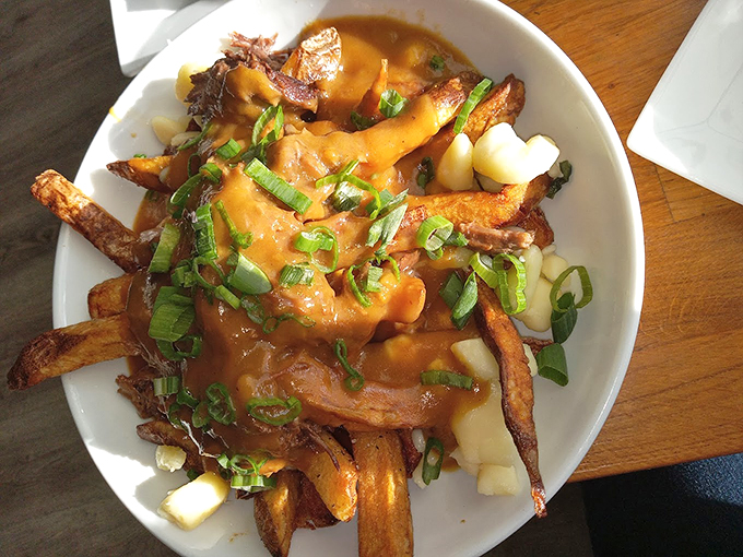 Hand-cut fries smothered in gravy and topped with fresh scallions &ndash; comfort food that hugs your soul. Photo credit: Cathy Kramer
