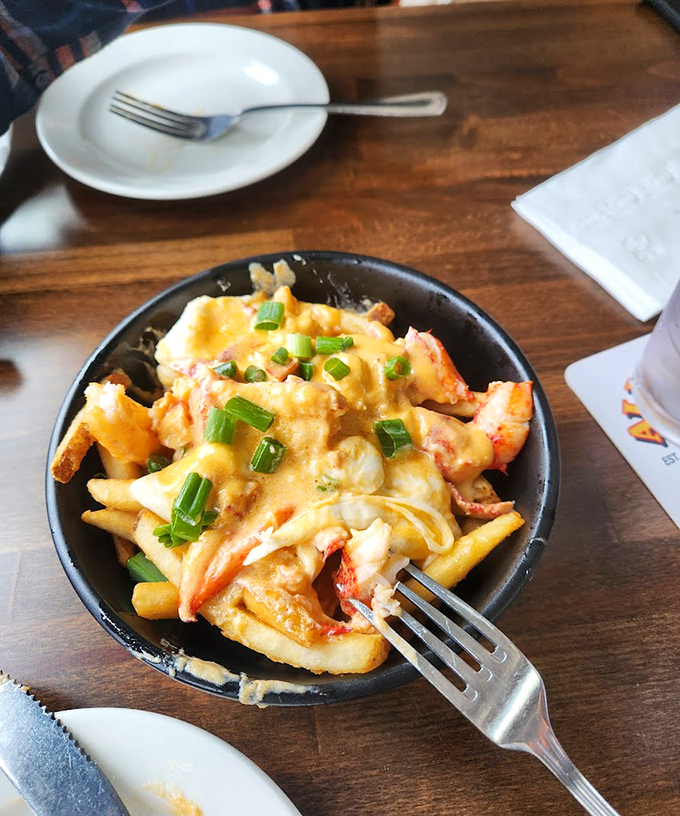 Golden fries smothered in lobster and cheese sauce &ndash; because sometimes you need your comfort food to wear a tuxedo. Photo credit: D L