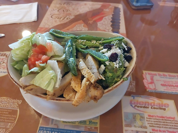 Fresh greens, grilled chicken, and crisp vegetables create a garden party in a bowl, proving healthy can be heavenly. Photo credit: David Carrizosa