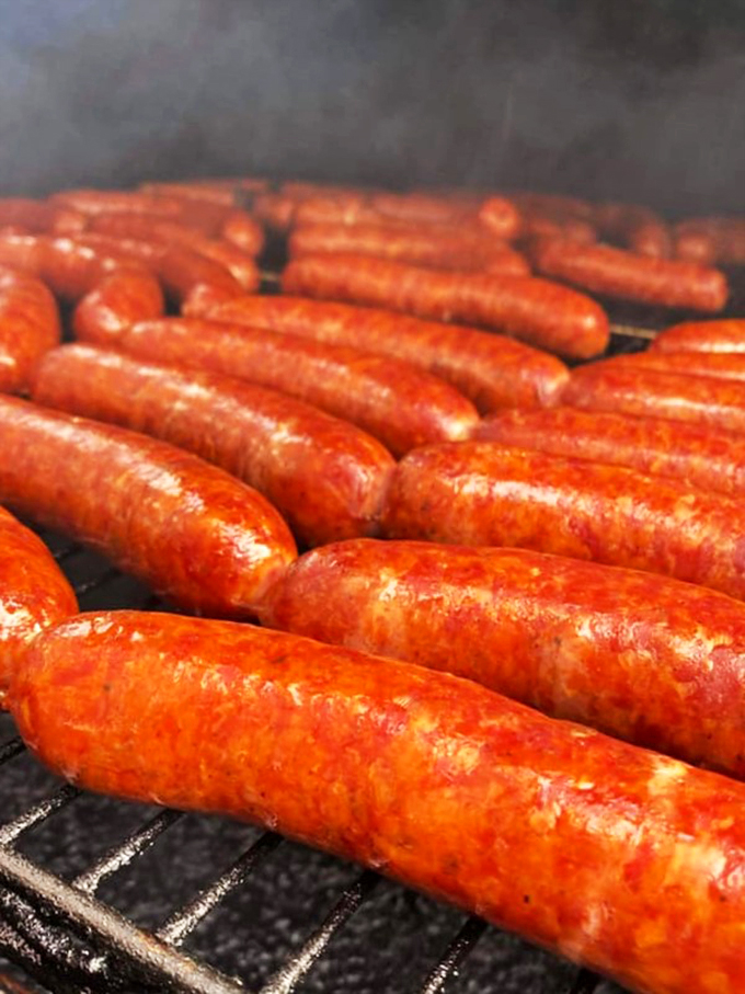 These sausages aren't just grilling, they're putting on a smoke show worthy of a standing ovation.