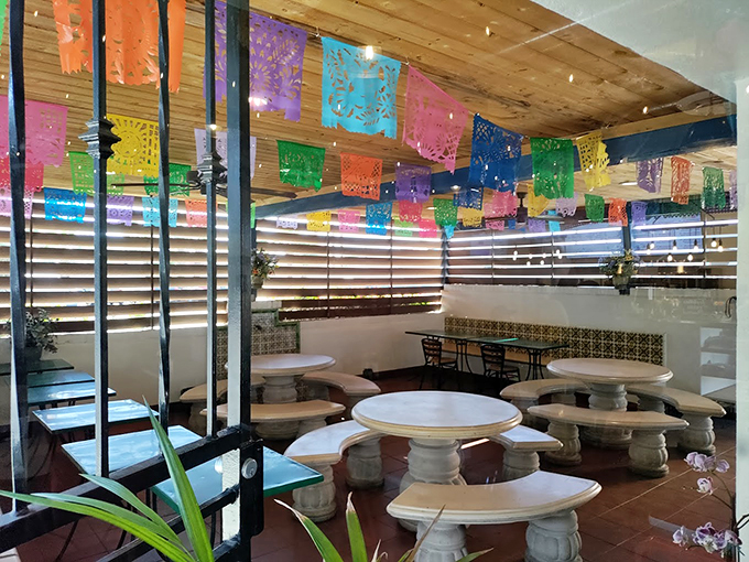 White marble tables beneath festive papel picado create an Instagram-worthy setting that's as welcoming as your abuela's dining room.