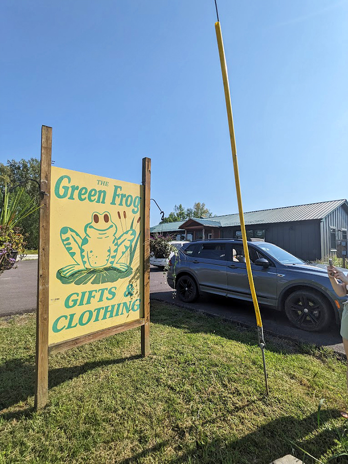The shop's cheerful sign stands proud against Vermont's blue skies, featuring their amphibian mascot with a welcoming grin. 