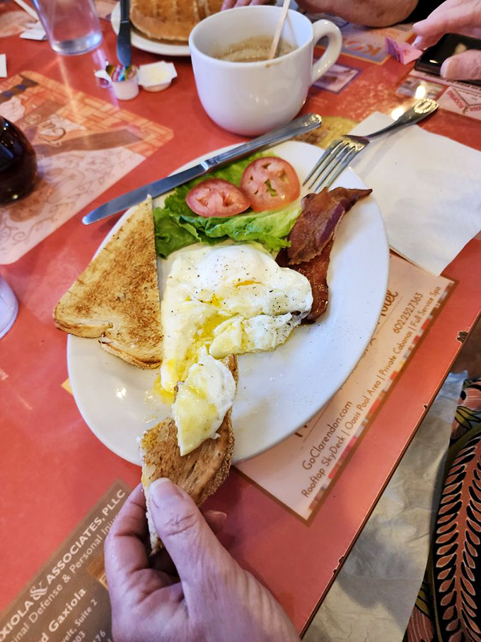 Eggs-actly what the doctor ordered! This classic breakfast plate at 5th Avenue Cafe is like a warm hug for your stomach, complete with crispy bacon and buttery toast. Photo credit: Mike B.