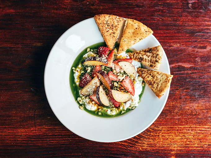 Fresh strawberries and creamy stracciatella create an artistic composition that's almost too pretty to eat. Almost.