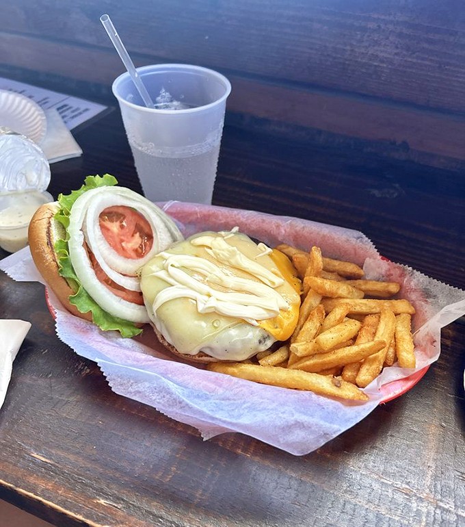 A burger that requires a game plan before the first bite – notice the structural integrity despite its impressive height? Engineering at its finest.