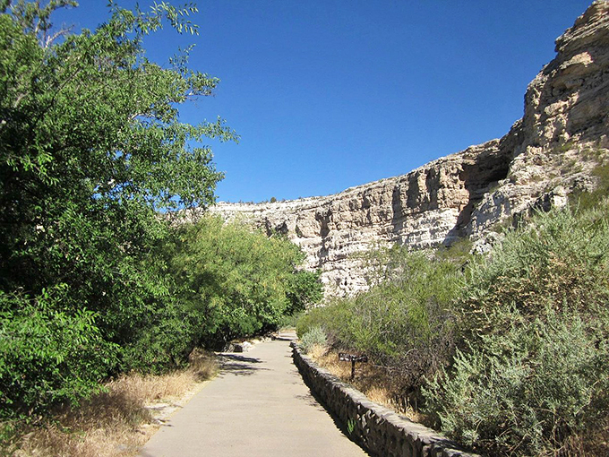 A winding path beckons adventure seekers through towering canyon walls, promising discoveries around every bend.