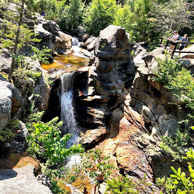 From this vantage point, visitors can safely observe the water's graceful descent through the rocky channel. 