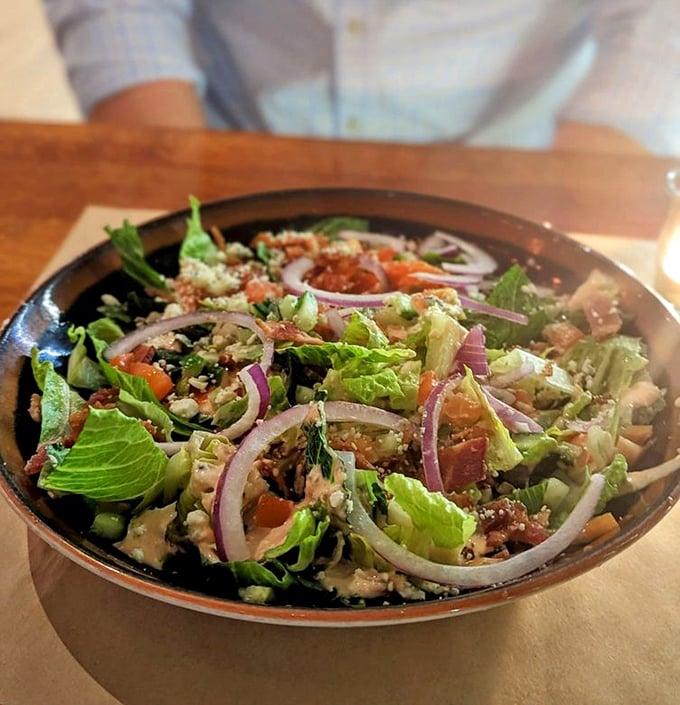 A deconstructed wedge salad that turns the humble iceberg into a sophisticated affair, with red onions adding perfect purple crescents.